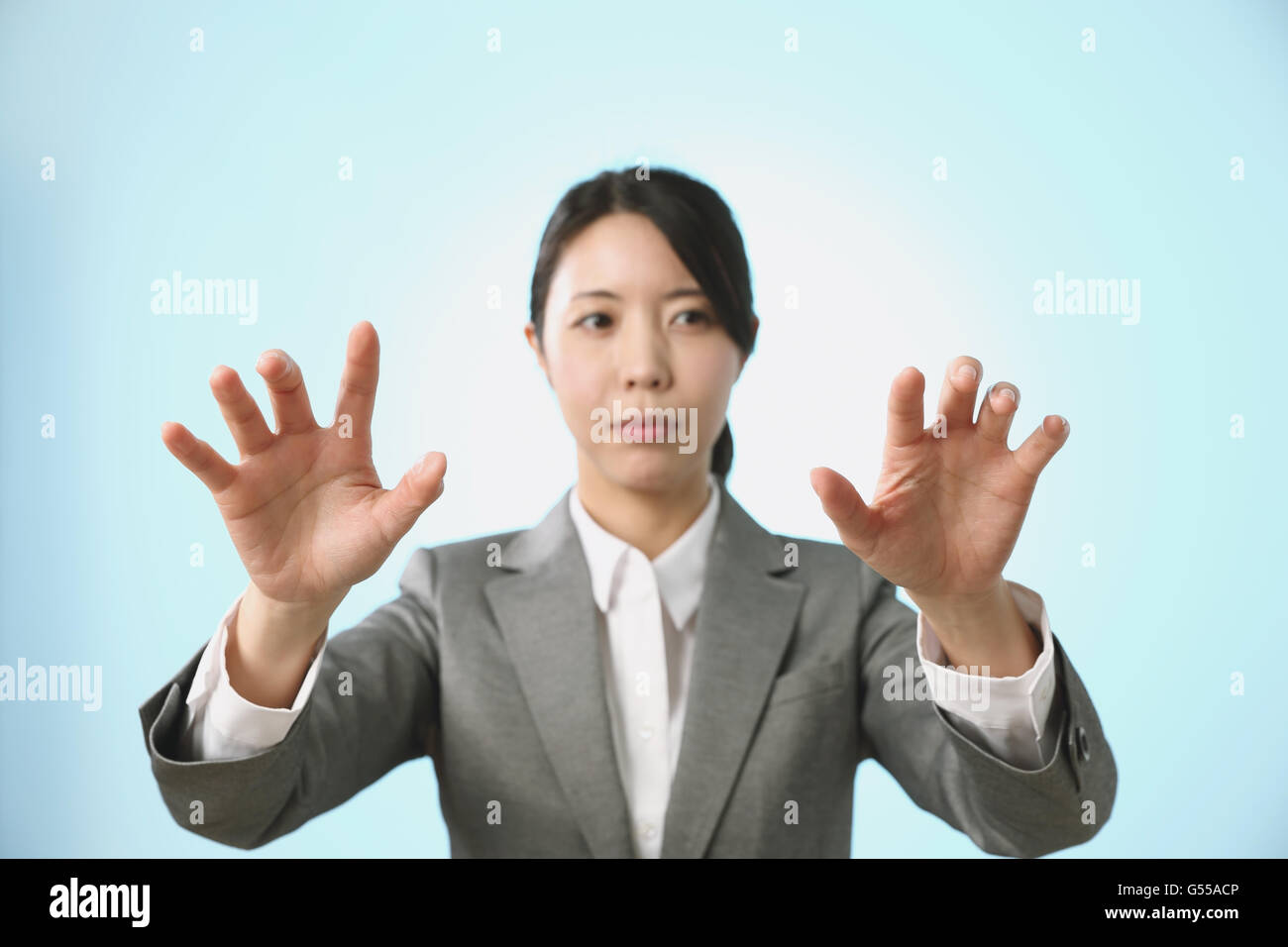 Japanese woman performing touch gesture Stock Photo - Alamy