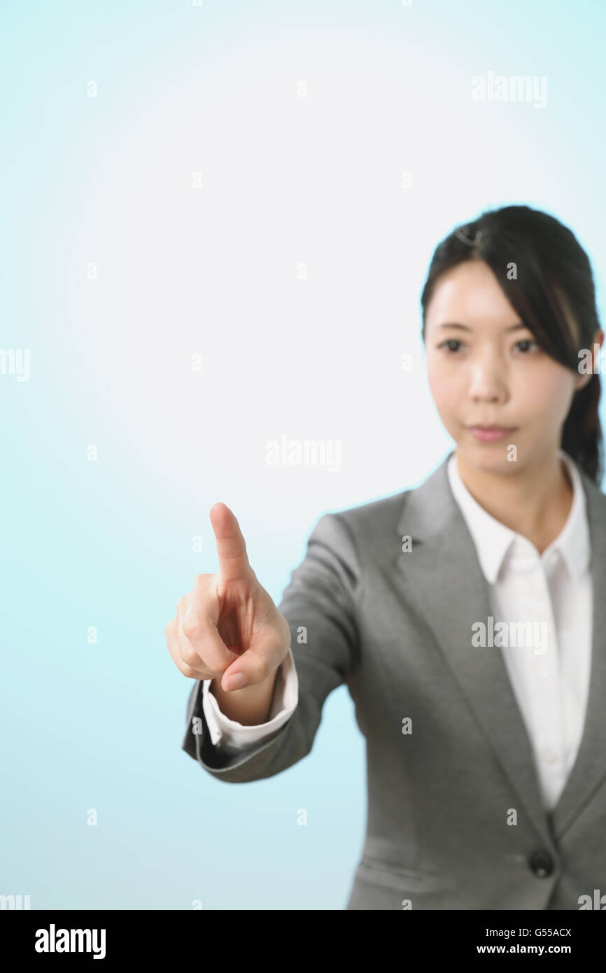 Japanese woman performing touch gesture Stock Photo - Alamy