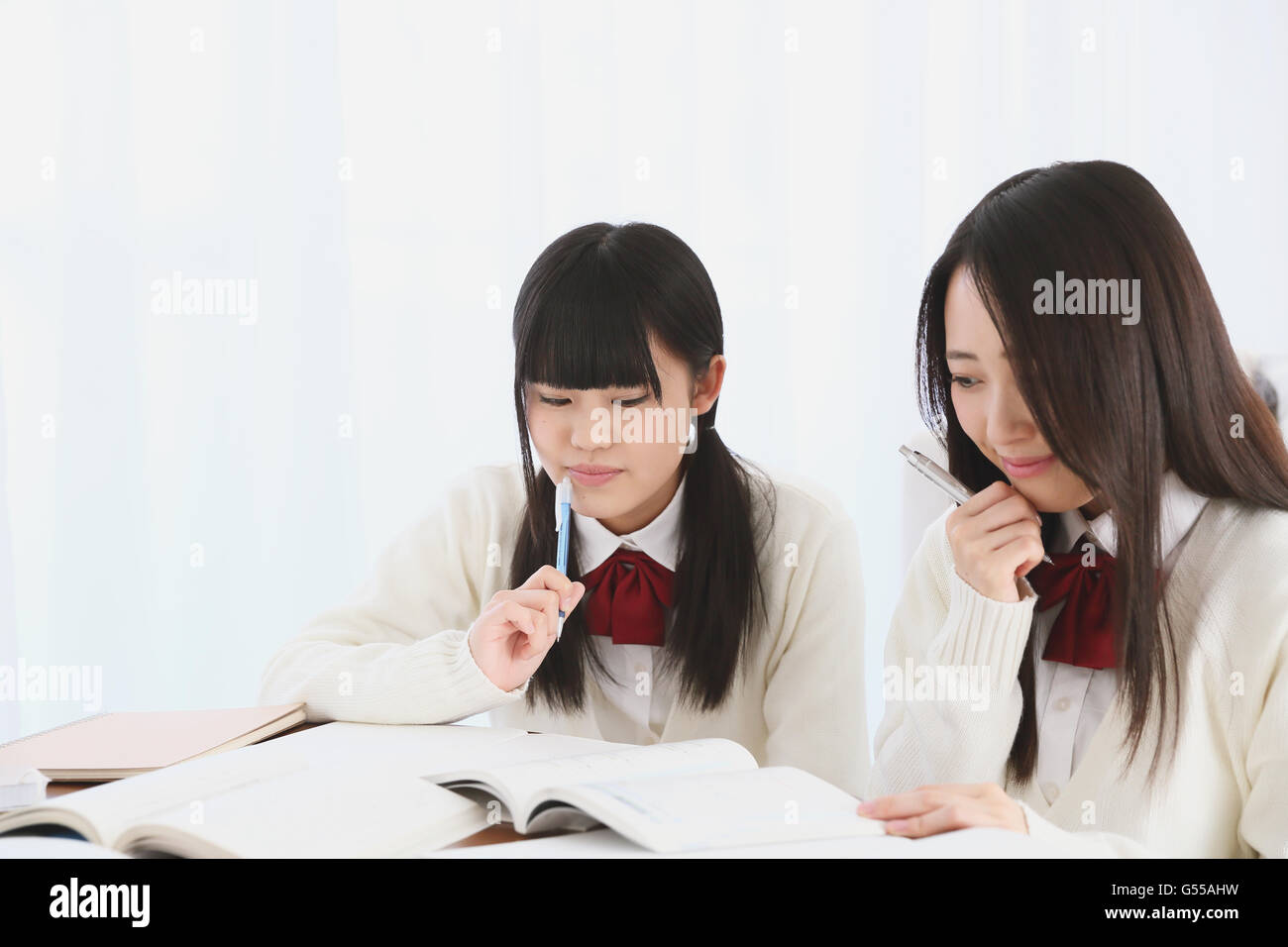 Japanese High-school students in uniform studying together Stock Photo ...