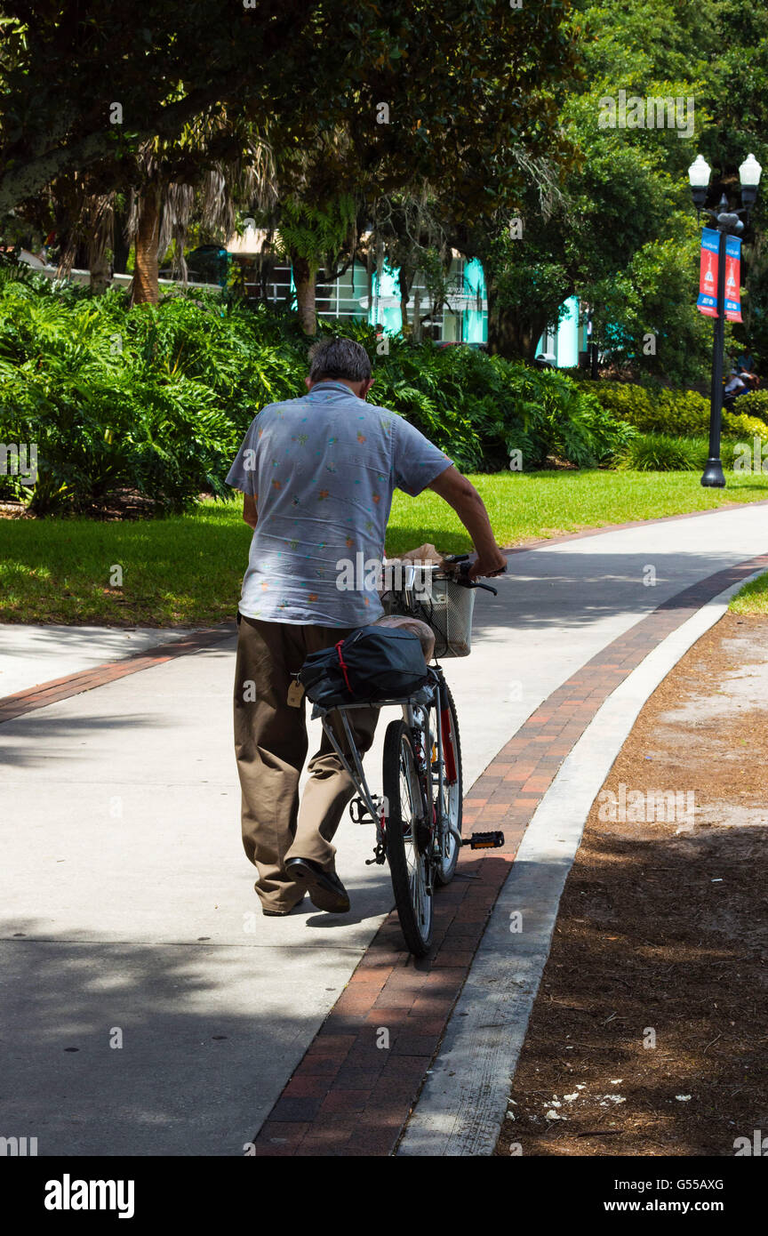 Old man walking alone bicycle hi-res stock photography and images - Alamy