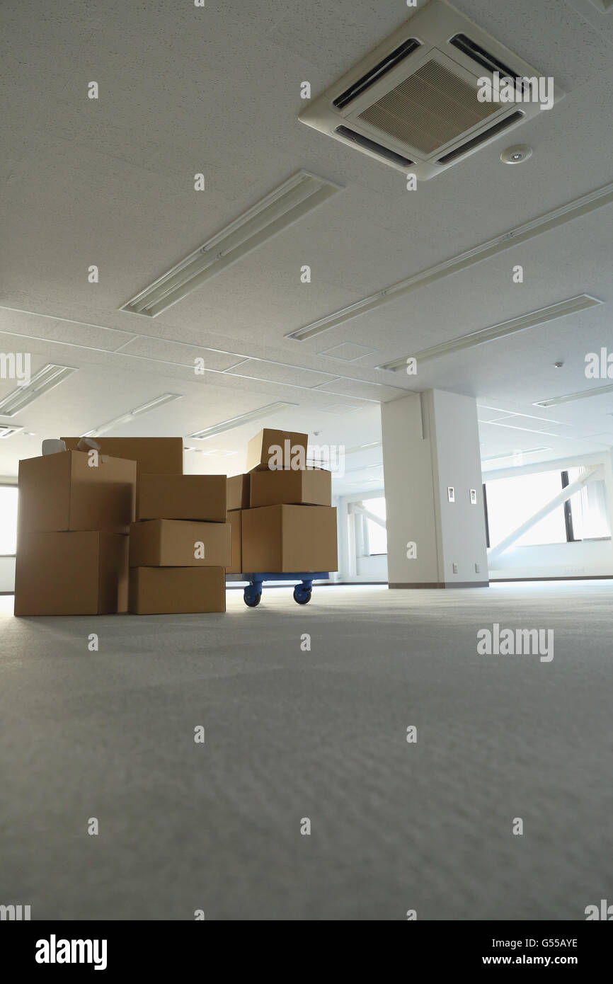 Boxes in an empty office Stock Photo - Alamy