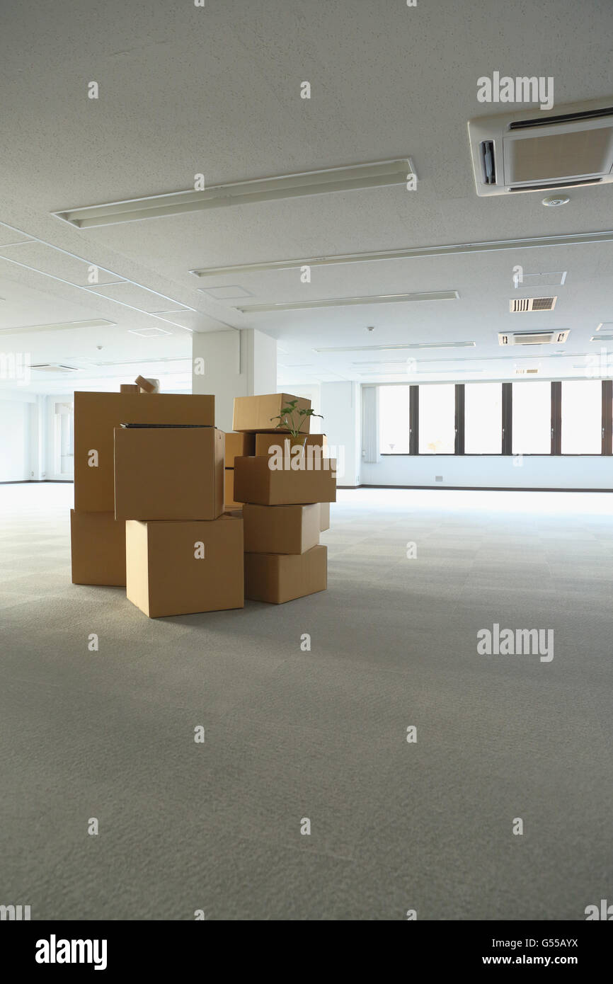 Boxes in an empty office Stock Photo - Alamy