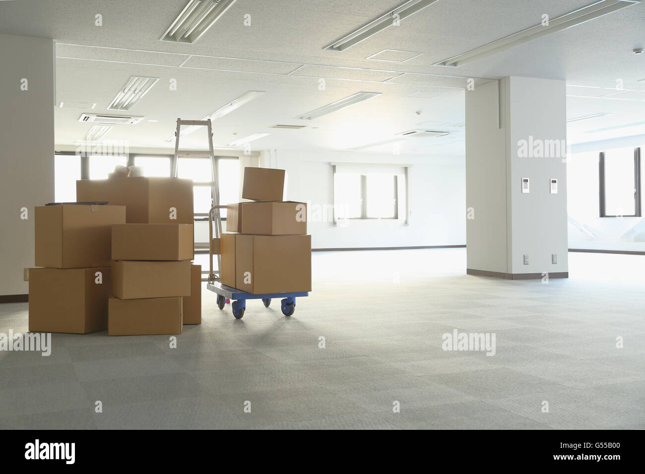 Boxes in an empty office Stock Photo - Alamy