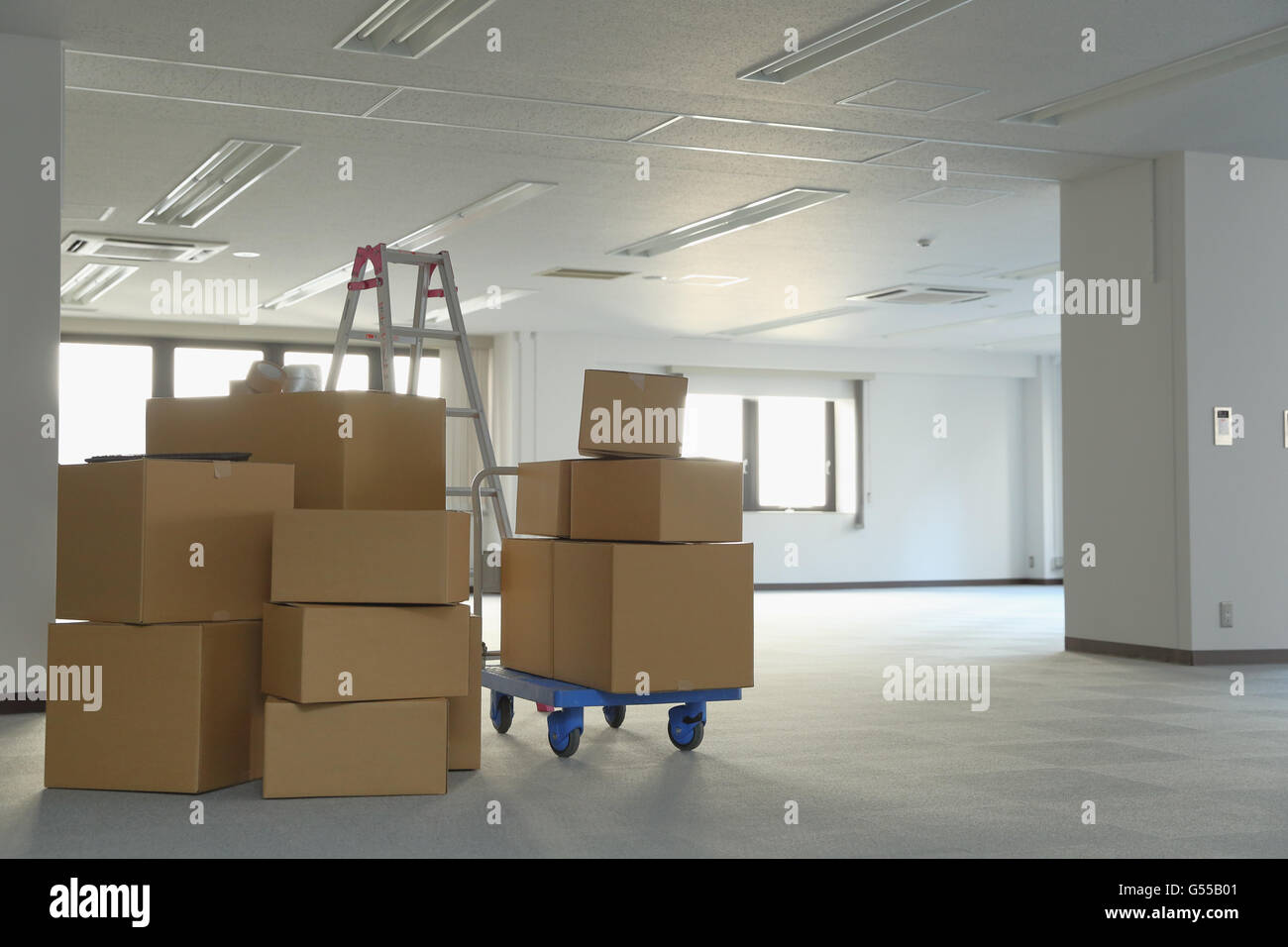 Boxes in an empty office Stock Photo - Alamy