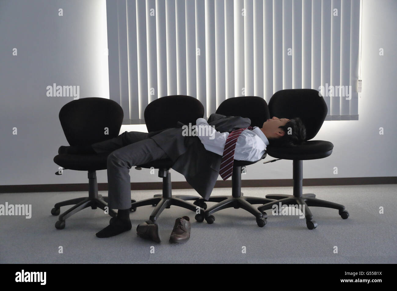 Japanese businessman sleeping on chairs Stock Photo - Alamy