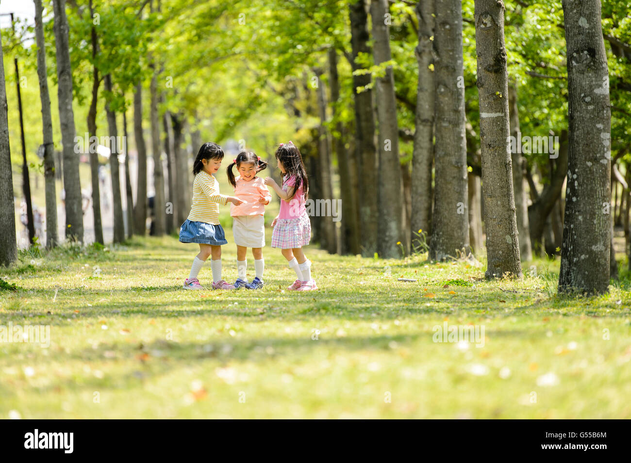 Kids playing in a park Stock Photo - Alamy