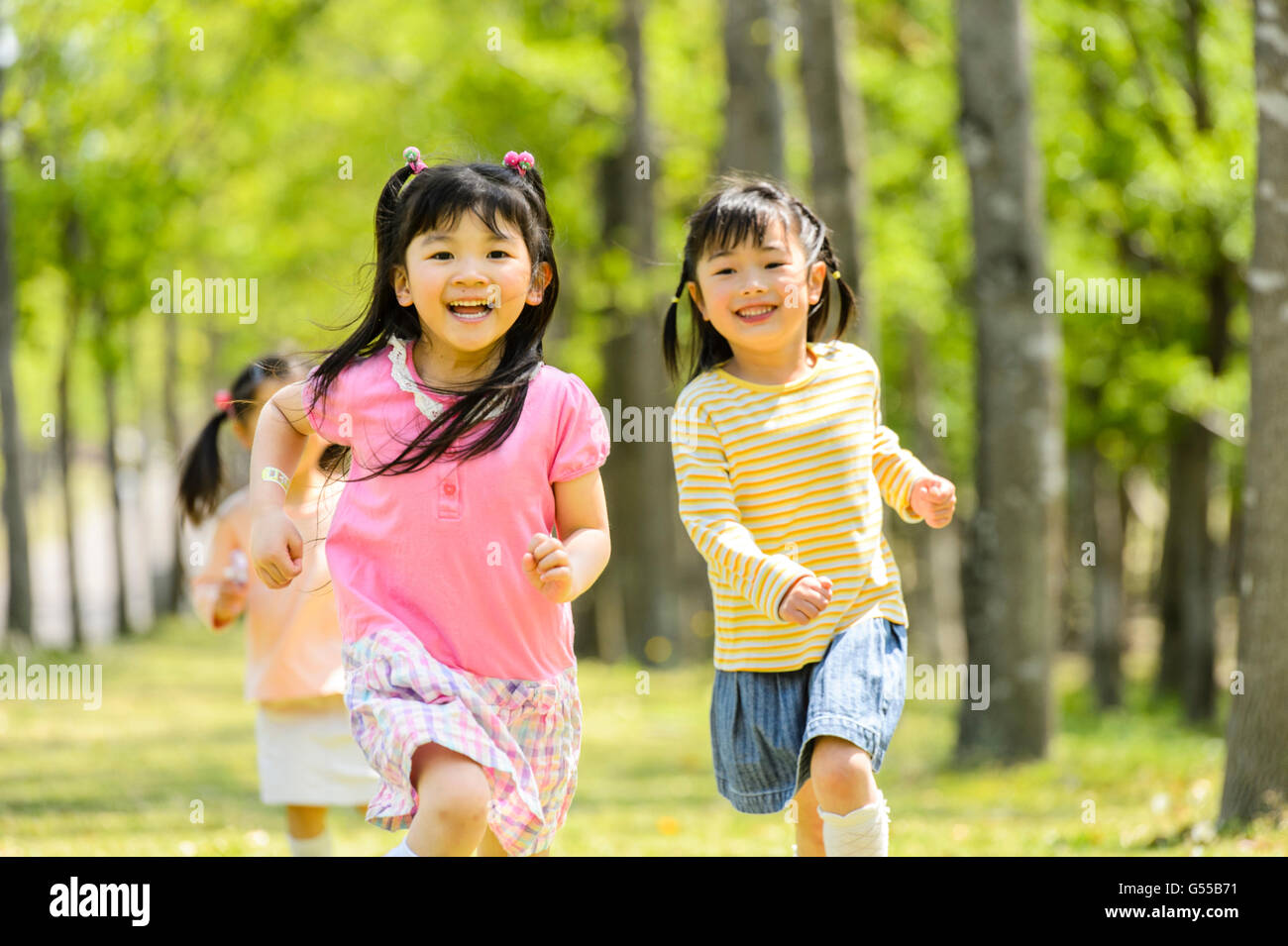 Kids playing in a park Stock Photo - Alamy