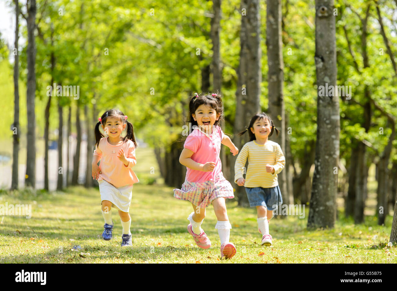 Kids playing in a park Stock Photo - Alamy