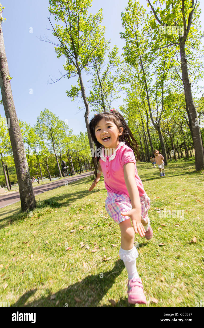 Kids playing in a park Stock Photo - Alamy