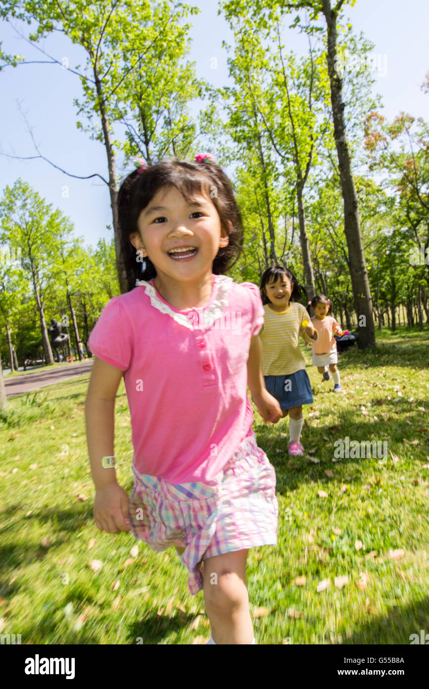 Kids playing in a park Stock Photo - Alamy