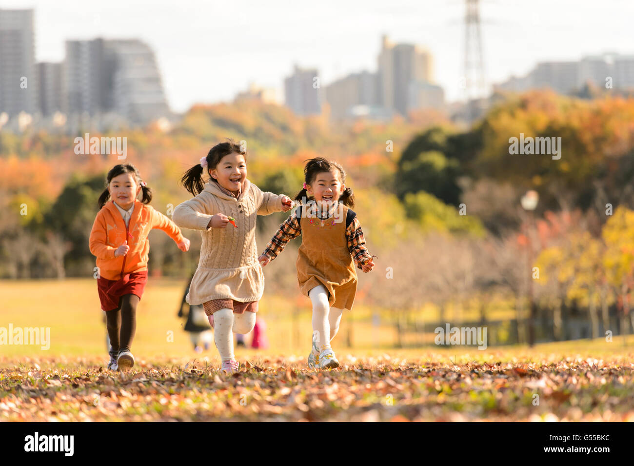 Kids playing in a park Stock Photo - Alamy