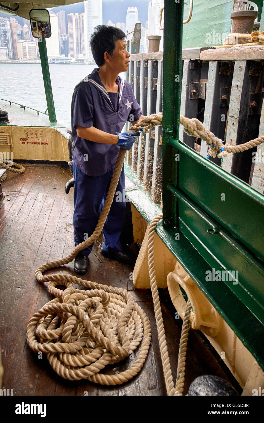 A Star Ferry deck hand helps secure the ferry as it arrives at the Tsim ...