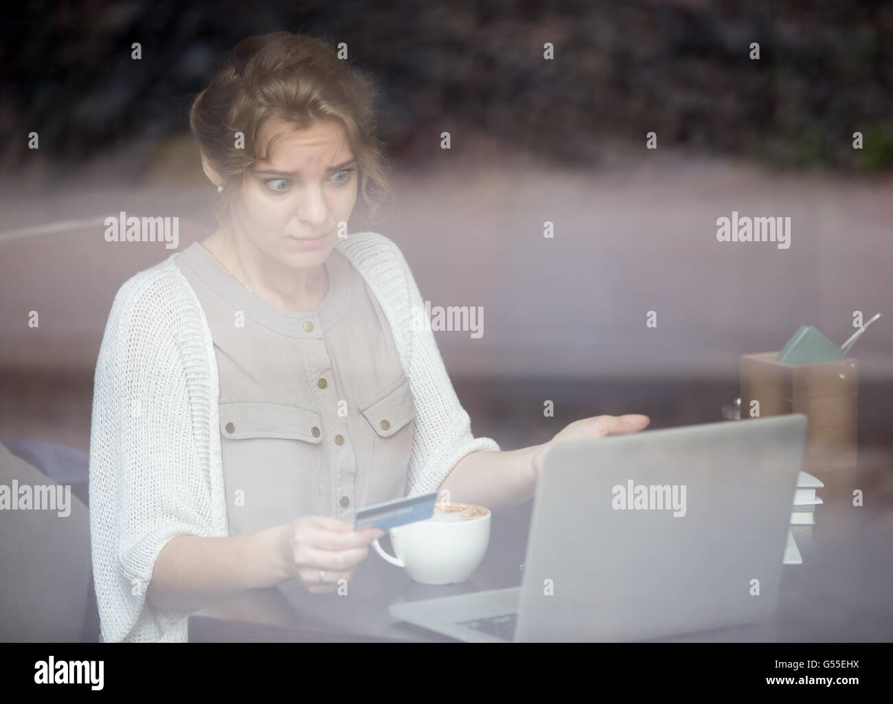 Portrait of young unhappy stressed beautiful female sitting in modern ...