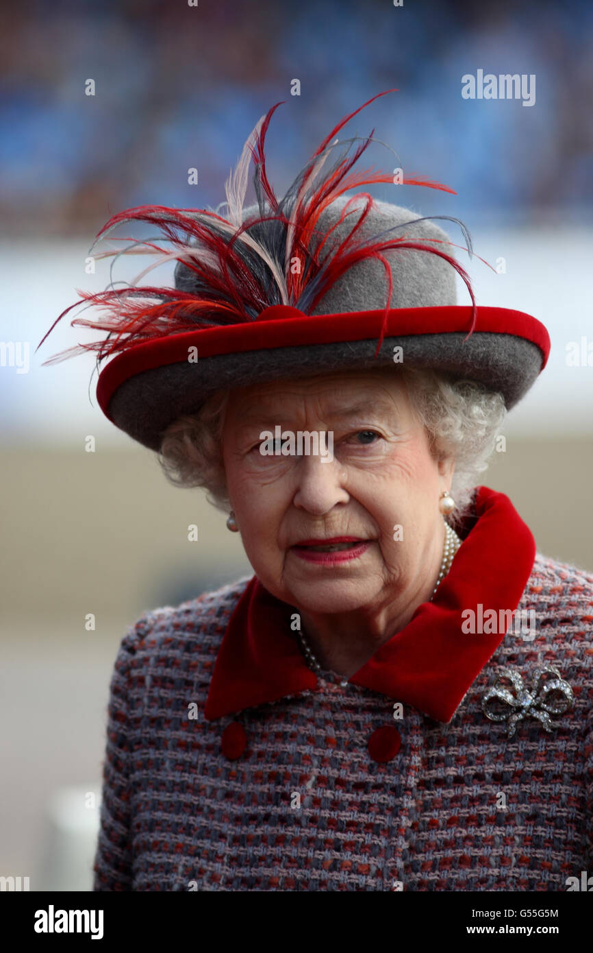 Queen Elizabeth II presents a trophy to the winner of the Land Rover ...