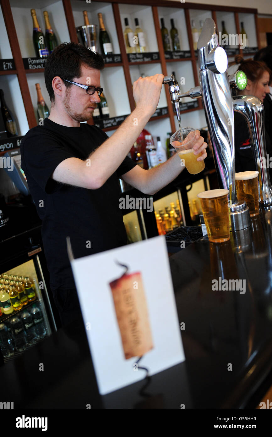 A bartender pours a pint of beer inside the Midday Wine bar at ...
