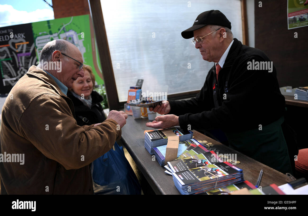 Racegoers purchase race cards at lingfield park racecourse hi-res stock ...