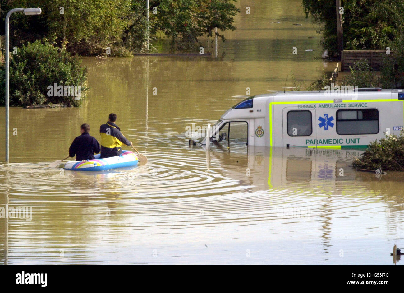 A Sussex ambulance remains partially submerged in floodwaters after the ...