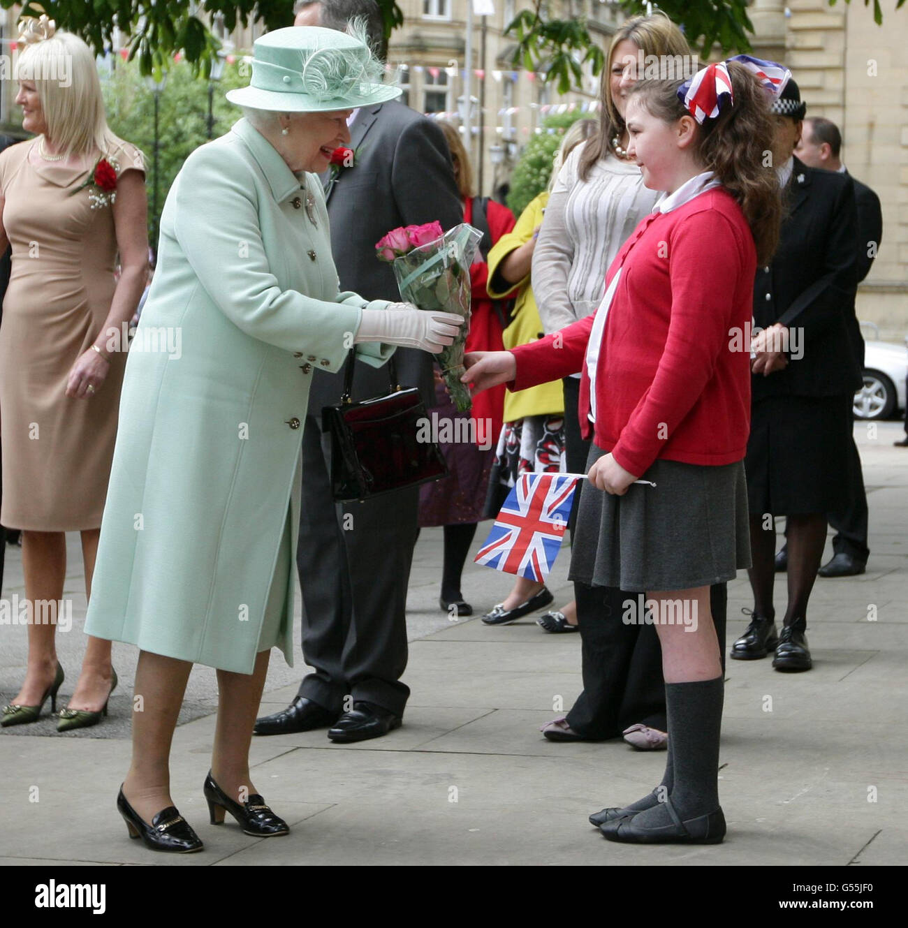 10-year-old Ellena Coglan from Accrington, presents a bouquet to Queen ...