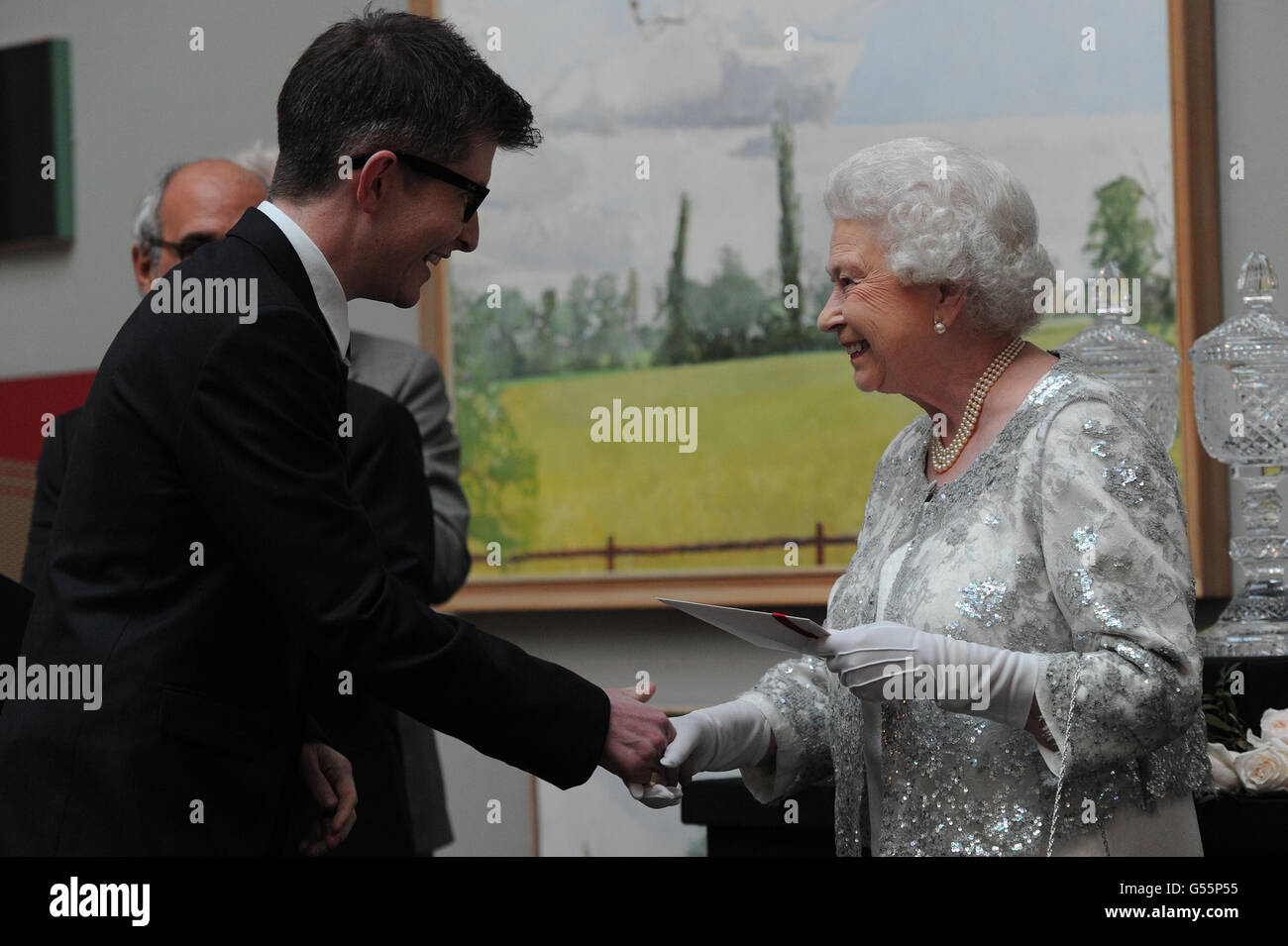 Queen Elizabeth II presents a Diamond Award for his contribution to ...