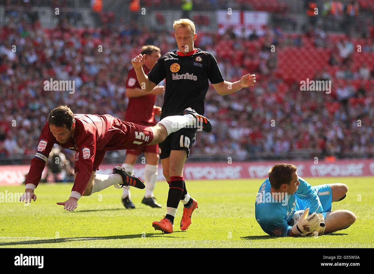 Cheltenham Town's Alan Bennett (left) takes a tumble over his ...