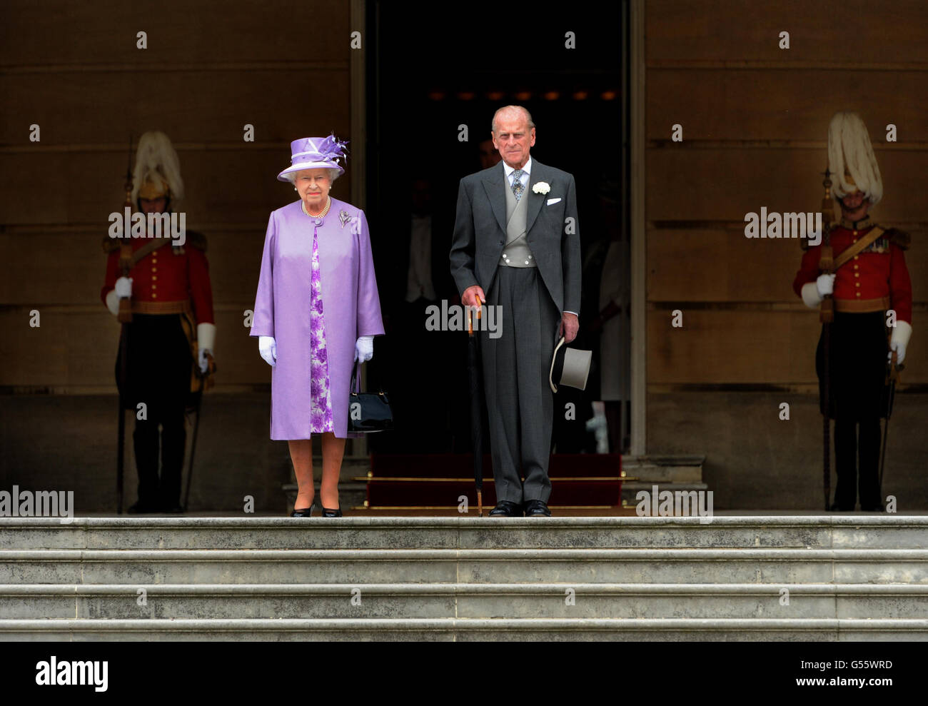 Queen Elizabeth II and the Duke of Edinburgh stand for the national ...