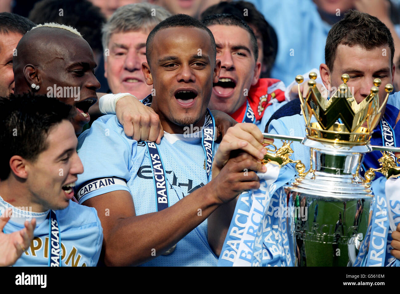 Manchester City captain Vincent Kompany (centre) lifts the trophy after ...