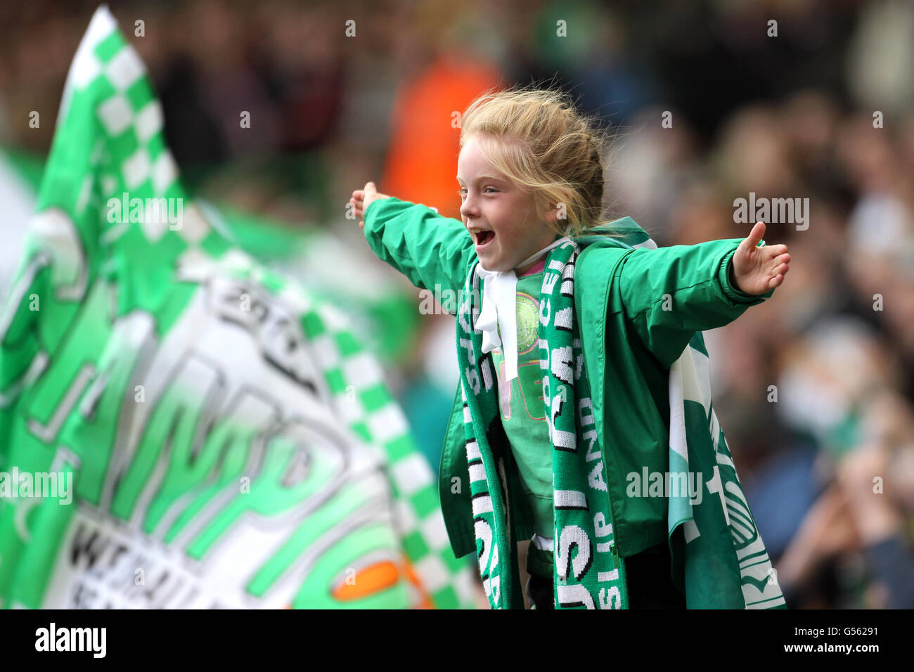 A young Celtic fan celebrates her side's victory in the stands Stock ...