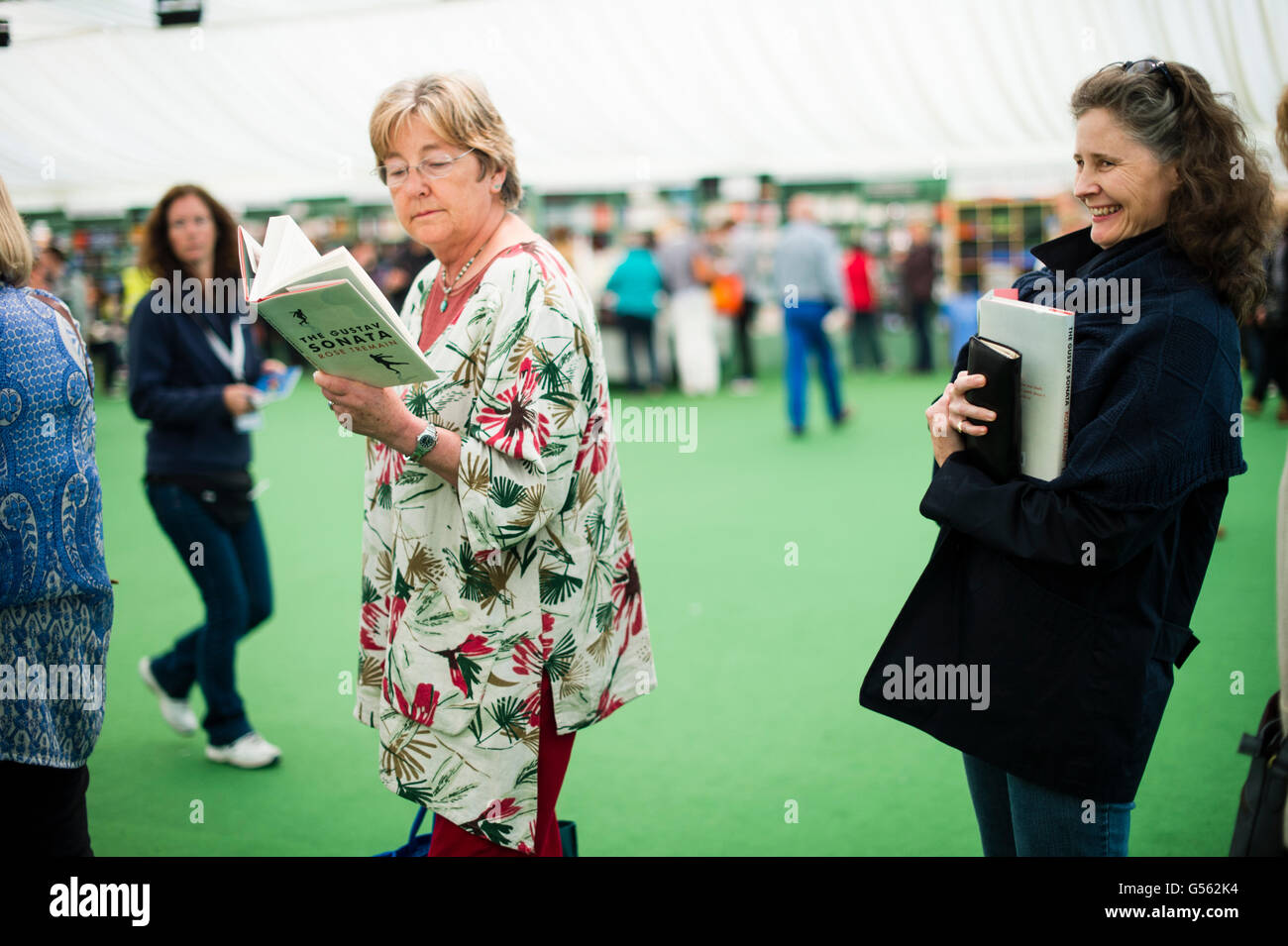 Women in the bookshop reading as they queue for a signing session at ...