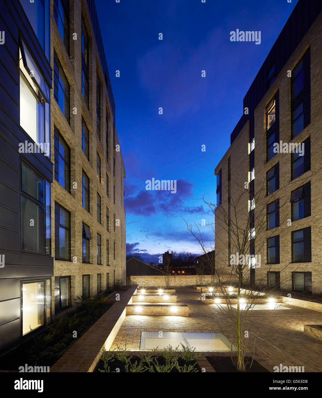 Dusk view across landscaped courtyard within development. Spring Mews ...