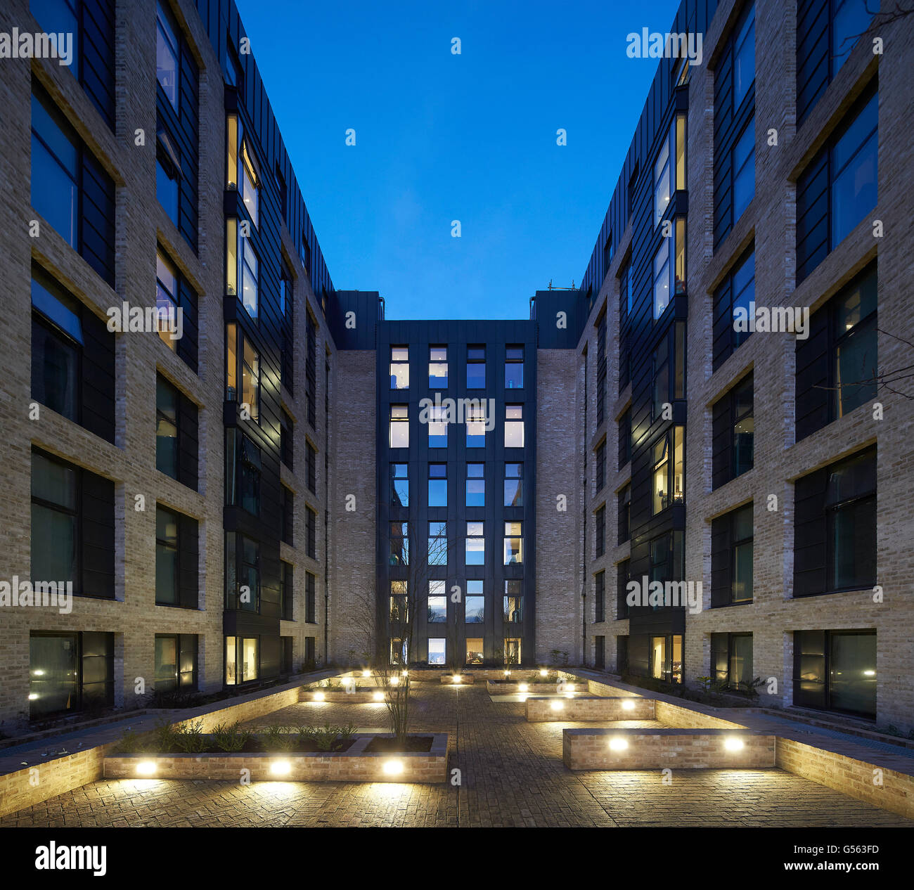 Dusk view across landscaped courtyard within development. Spring Mews ...