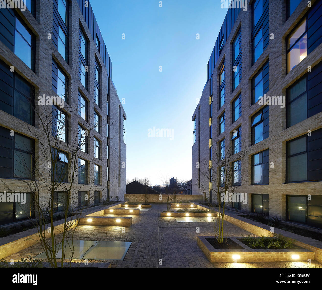 Dusk view across landscaped courtyard within development. Spring Mews ...