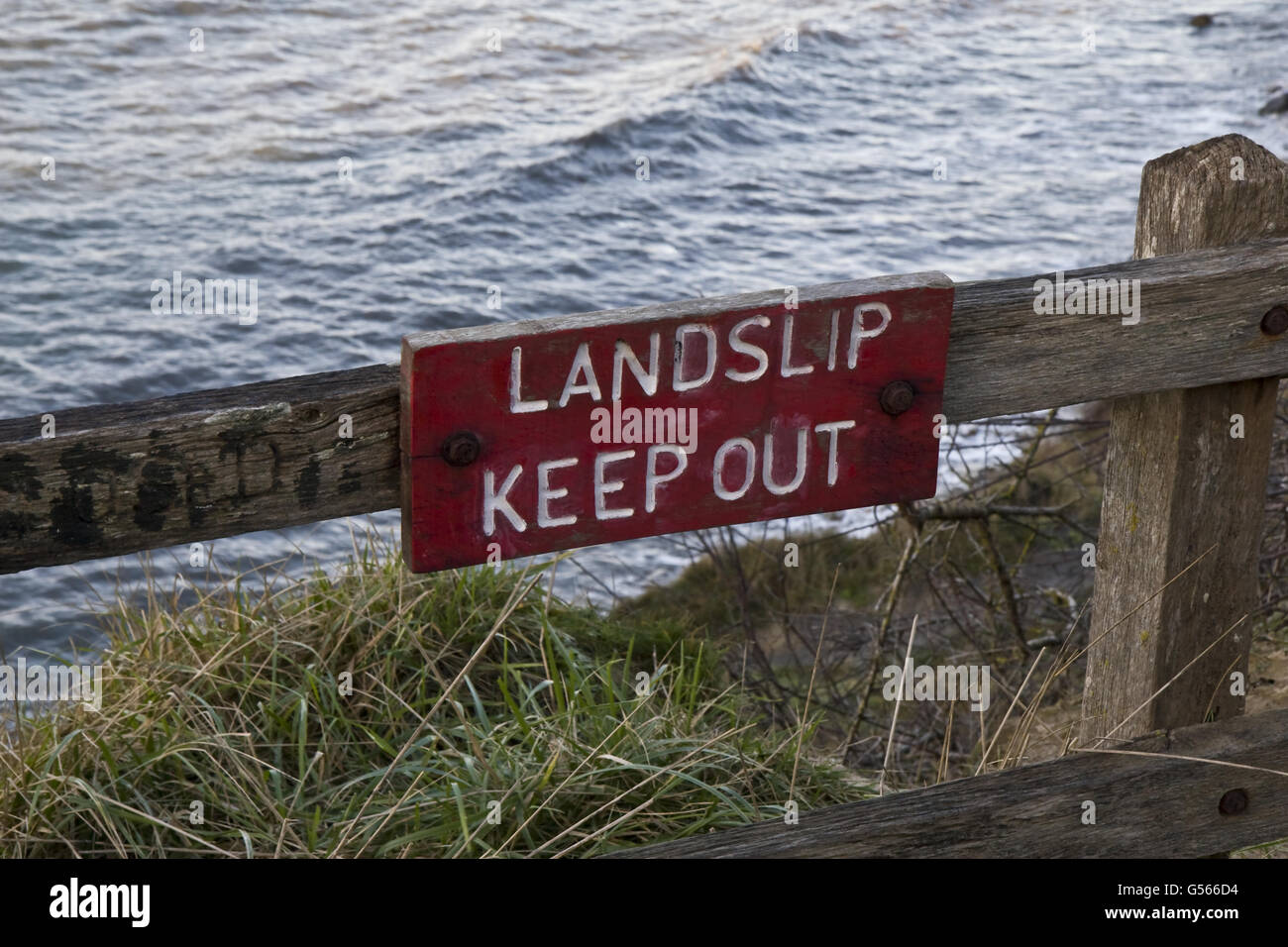 'Landslip, Keep Out' warning sign at edge of cliff, Osmington, Dorset ...