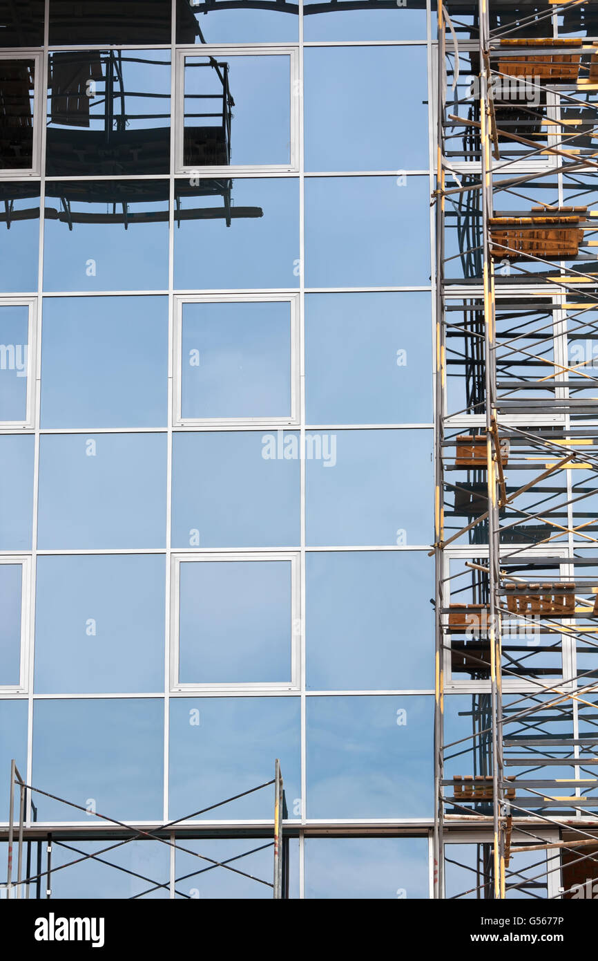 Reflection of building designs in windows of an under construction ...