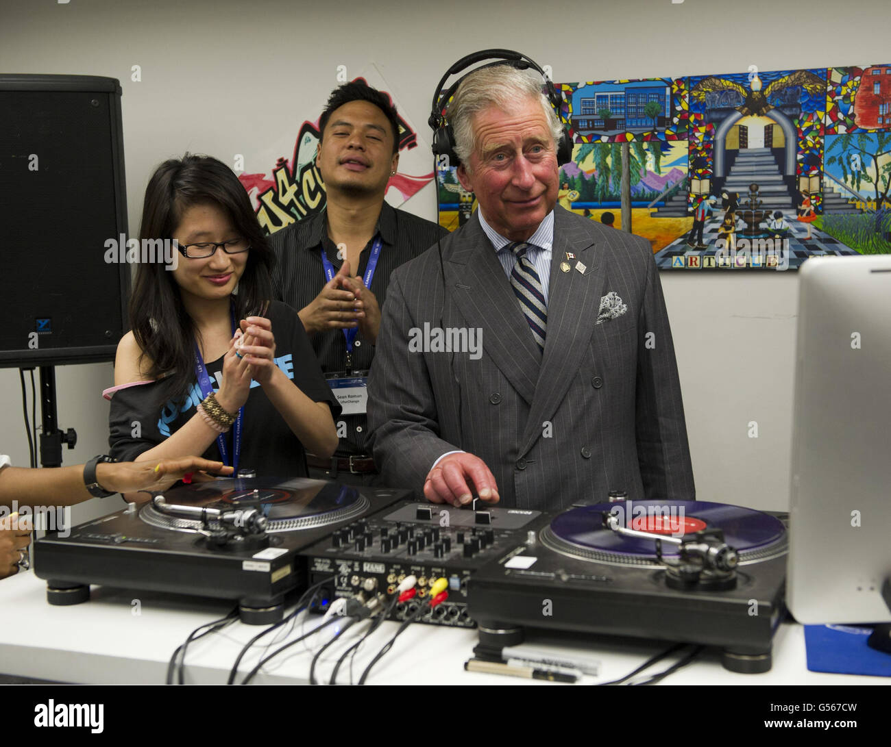 Prince Charles learns how to scratch and fade with a turntable during a ...