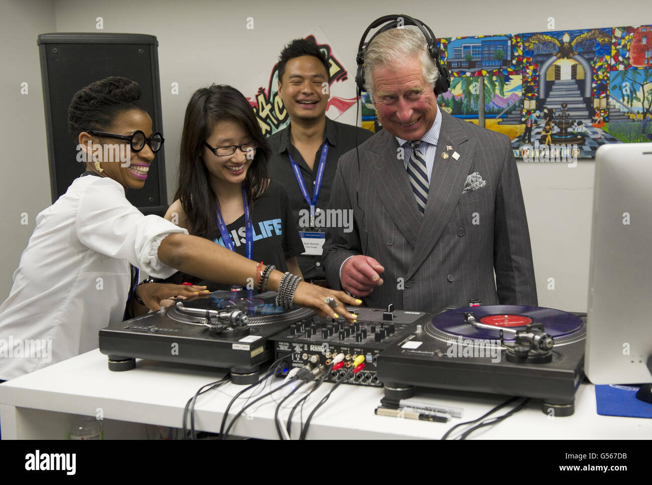 Prince Charles learns how to scratch and fade with a turntable during a ...
