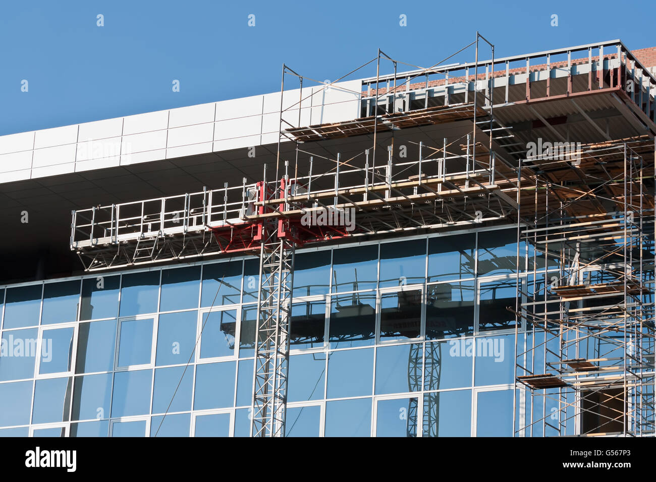Reflection of building designs in windows of an under construction ...