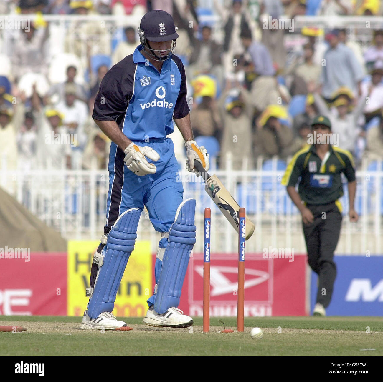 England's Graeme Hick (L) begins his walk back to the pavilion after ...