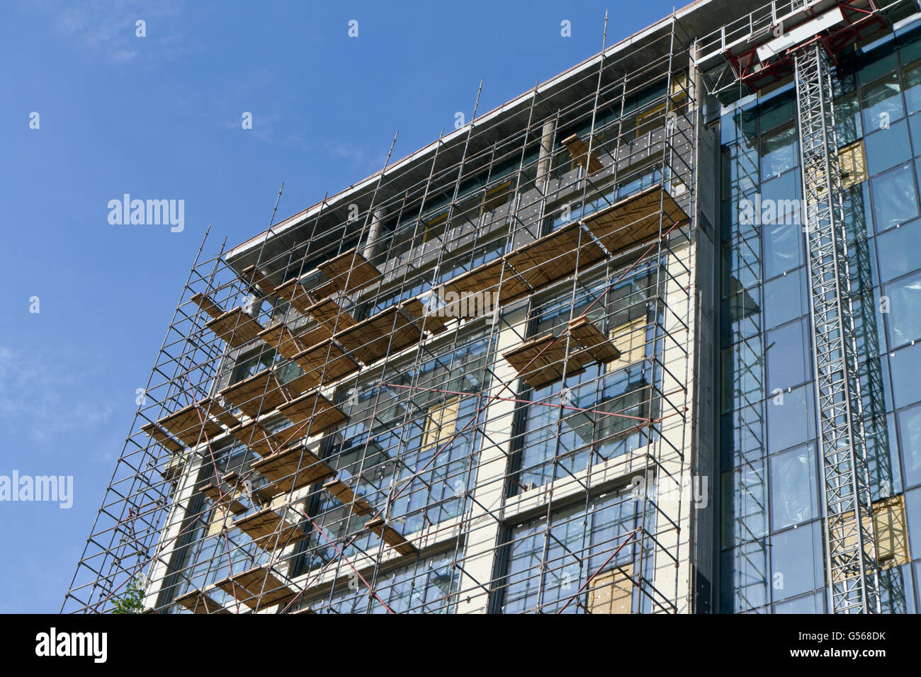 Incomplete modern building under construction with scaffolding Stock ...