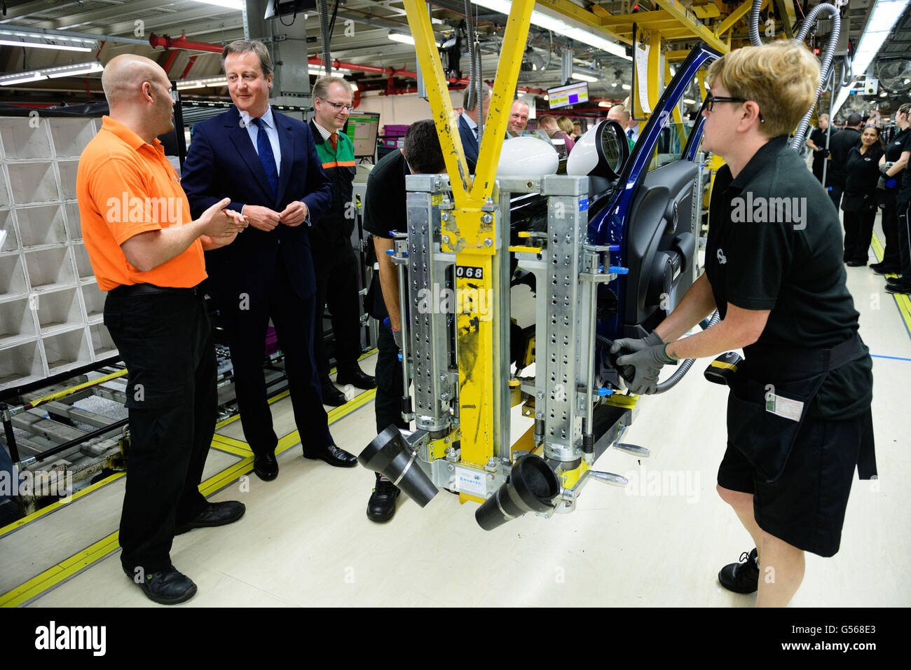 Prime Minister David Cameron (second left) tours the BMW Mini plant in ...