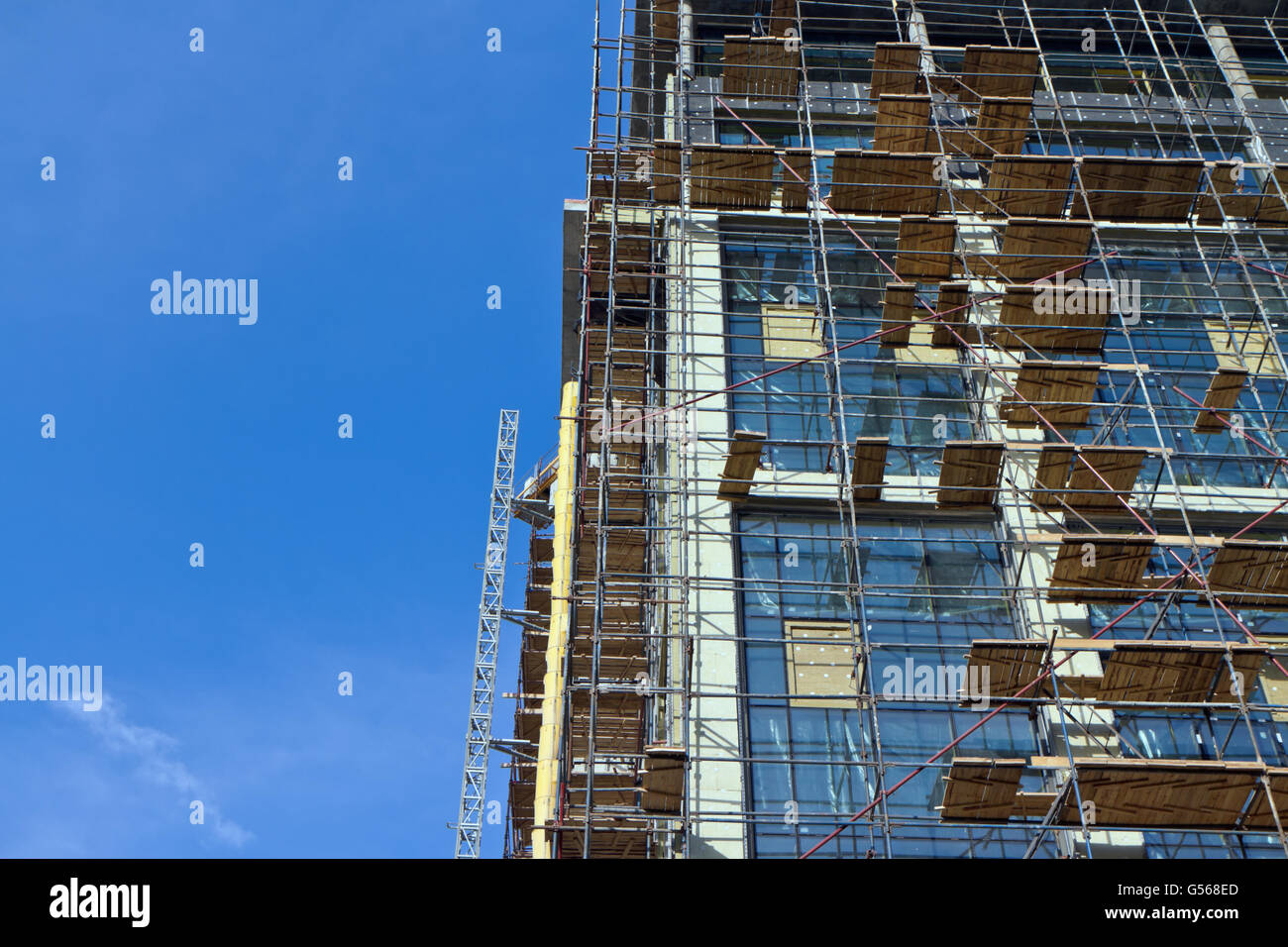 Incomplete modern building under construction with scaffolding Stock ...
