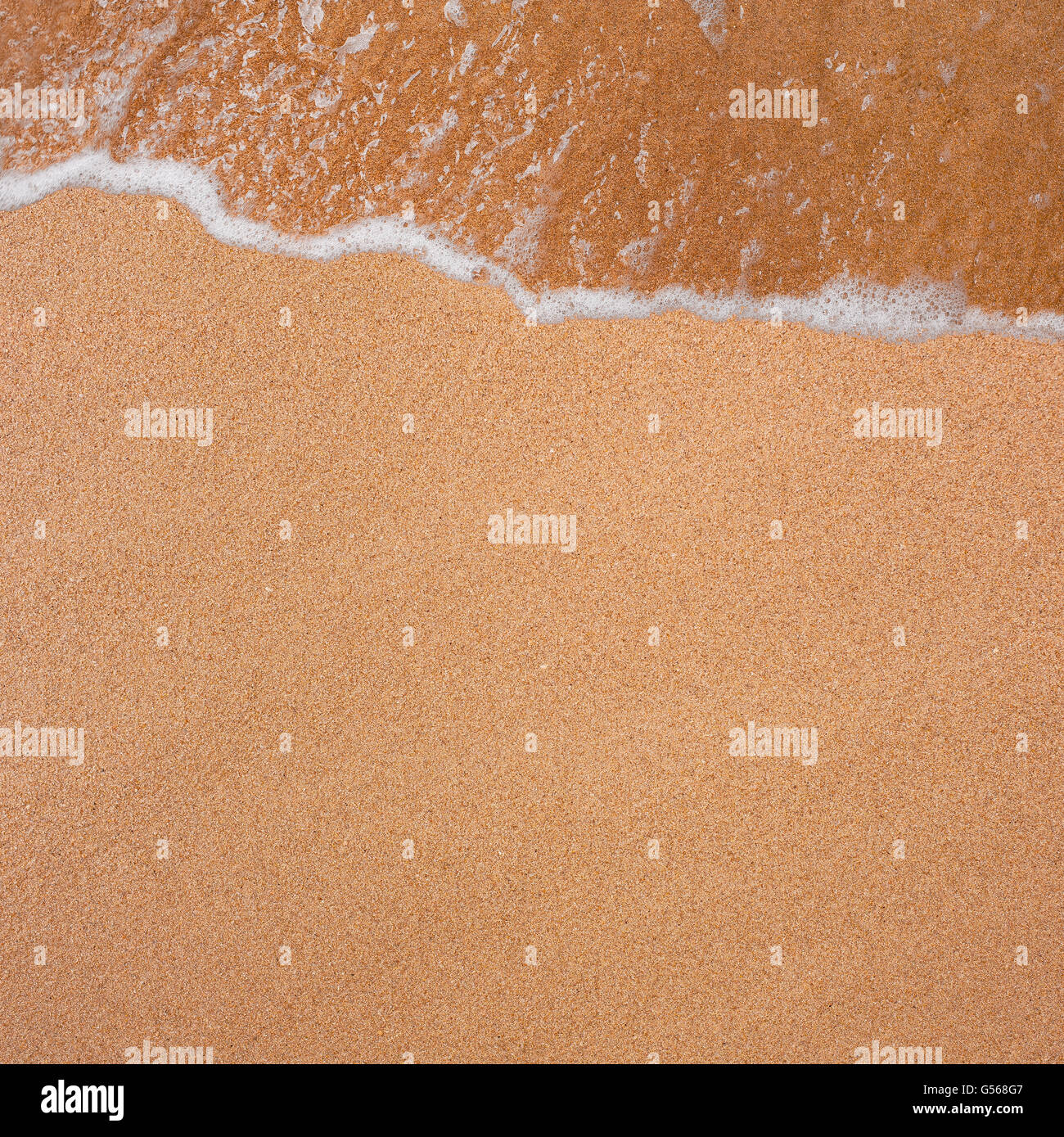 Natural background from the sand and waves on the beach Stock Photo - Alamy