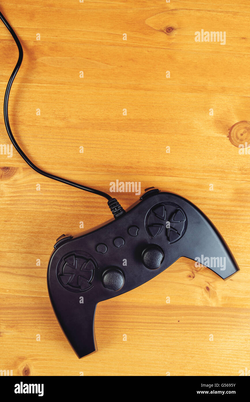 Gamepad controller on wooden desk, flat lay top view, gaming and ...