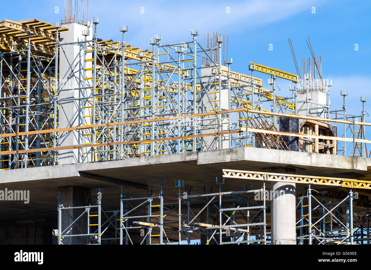 Incomplete modern building under construction with scaffolding detail ...