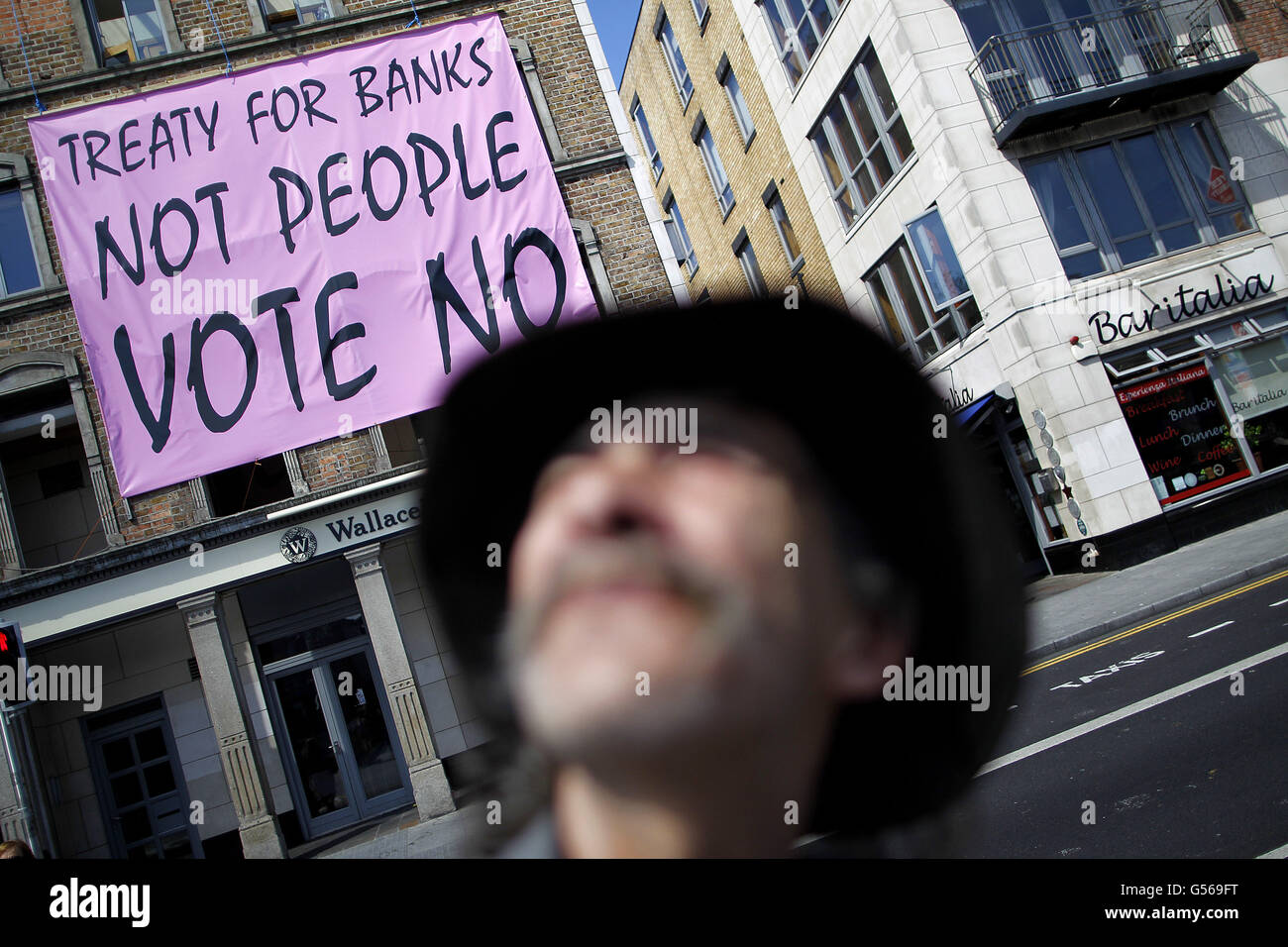 A large banner advocating a no vote hangs from the buildings owned by ...