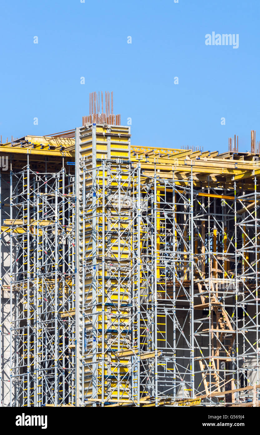 Incomplete modern building under construction with scaffolding detail ...