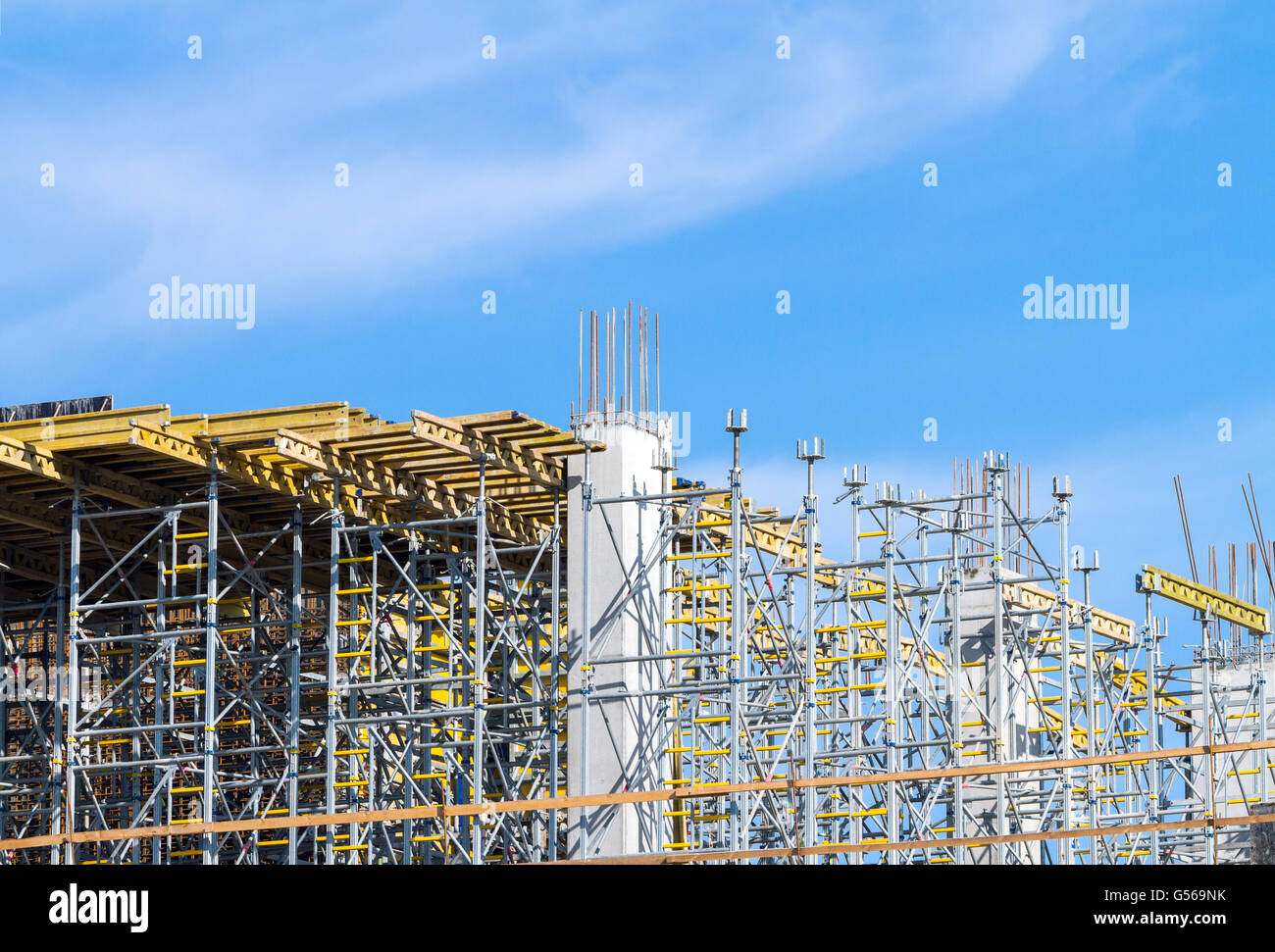 Incomplete modern building under construction with scaffolding detail ...
