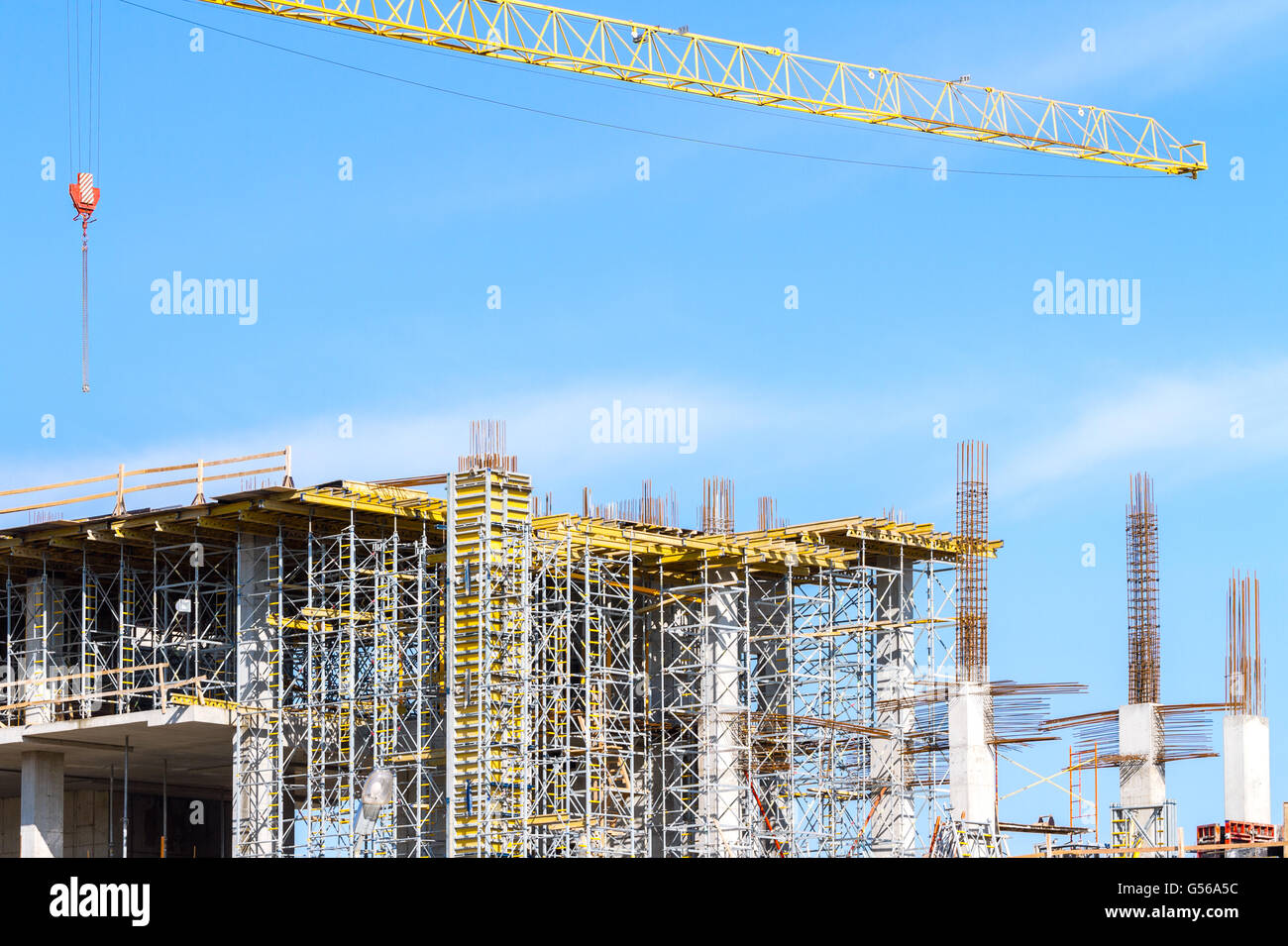 Incomplete modern building under construction with scaffolding detail ...