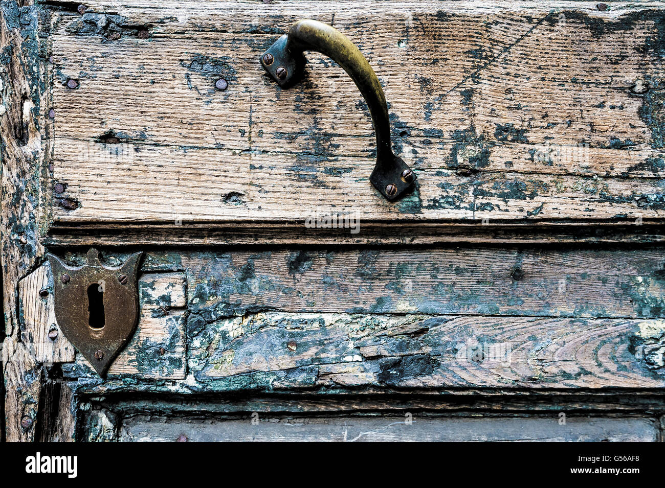 Patina on Distressed Old Door with handle and keyhole Stock Photo - Alamy