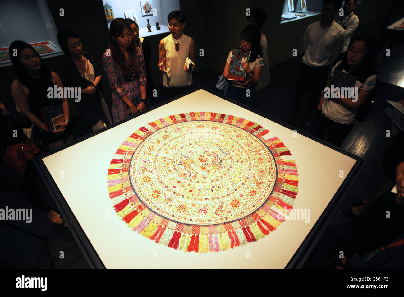 Singapore. 21st June, 2016. People look at a piece of embroided ...