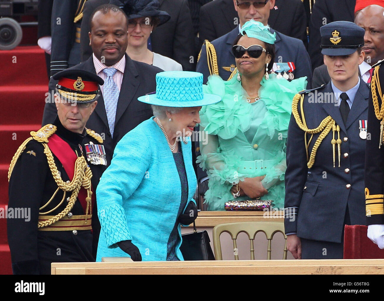 Queen Elizabeth II walks past King Mswati III of Swaziland and ...